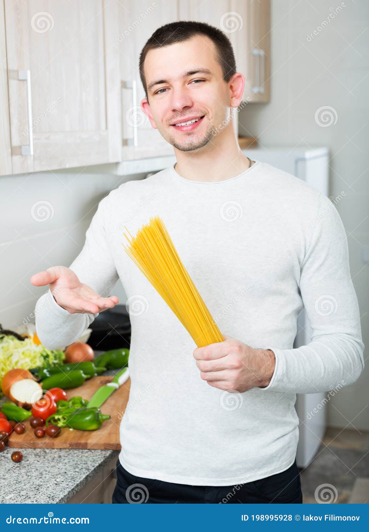 Man Holding Spaghetti at Kitchen Stock Photo - Image of cooking ...