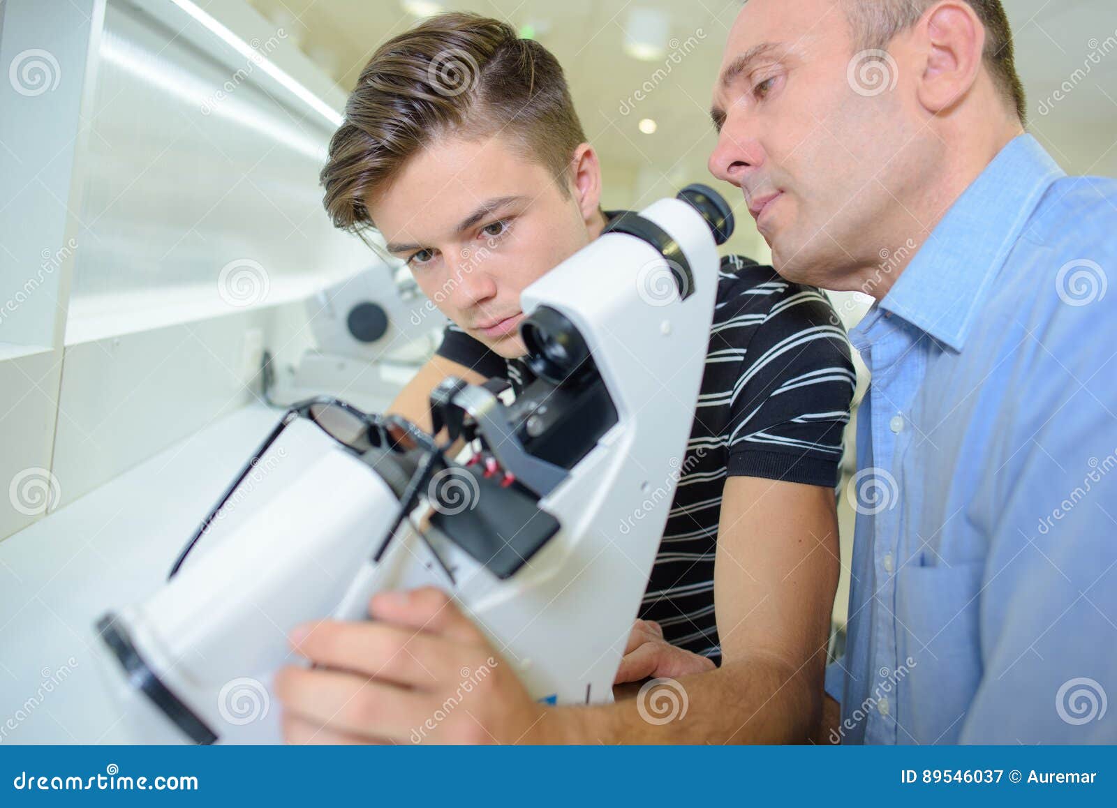 Man Holding Spectacles in Microscope Stock Image - Image of electronic ...
