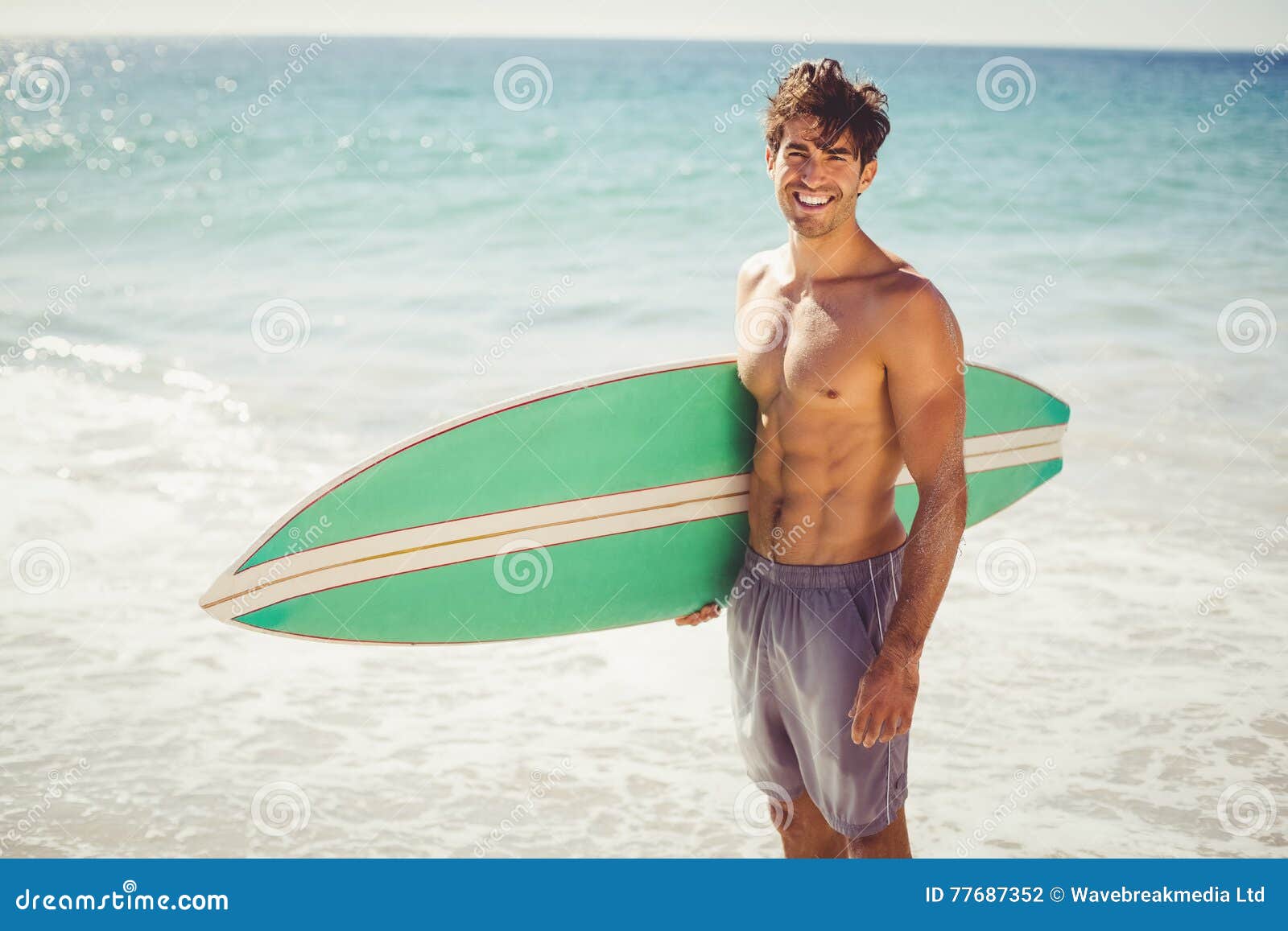 Man Holding Surfboard on Beach Stock Photo - Image of handsome, male ...