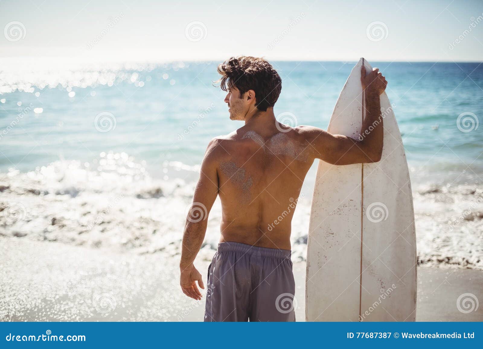 Man Holding Surfboard on Beach Stock Image - Image of adventure ...