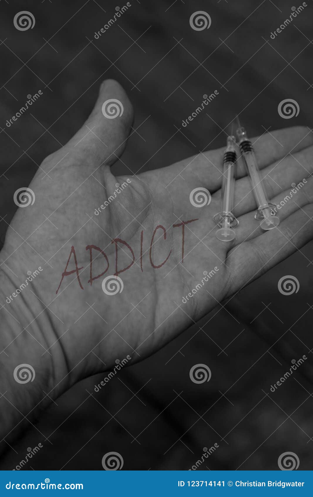 Man Holding Syringes Needles with the Word Addict Written on His Hands ...
