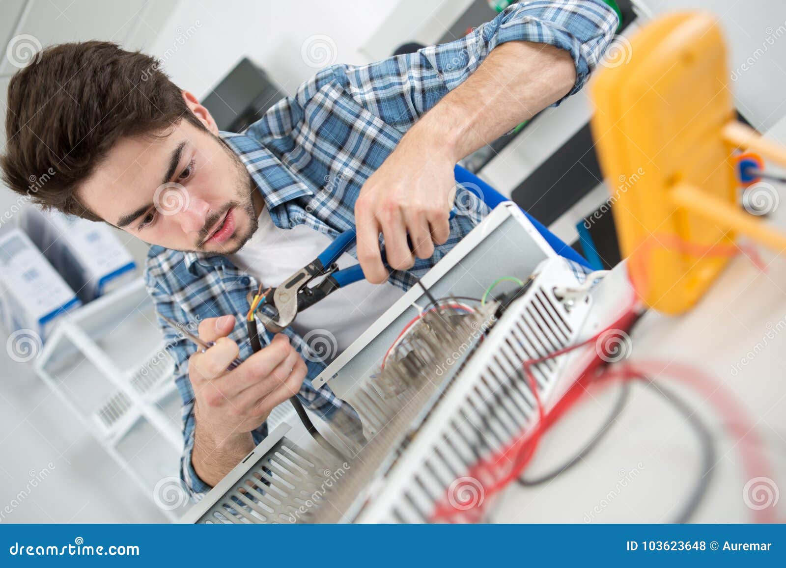 Man Holding Tools while Fixing Device Stock Photo - Image of circuitry ...