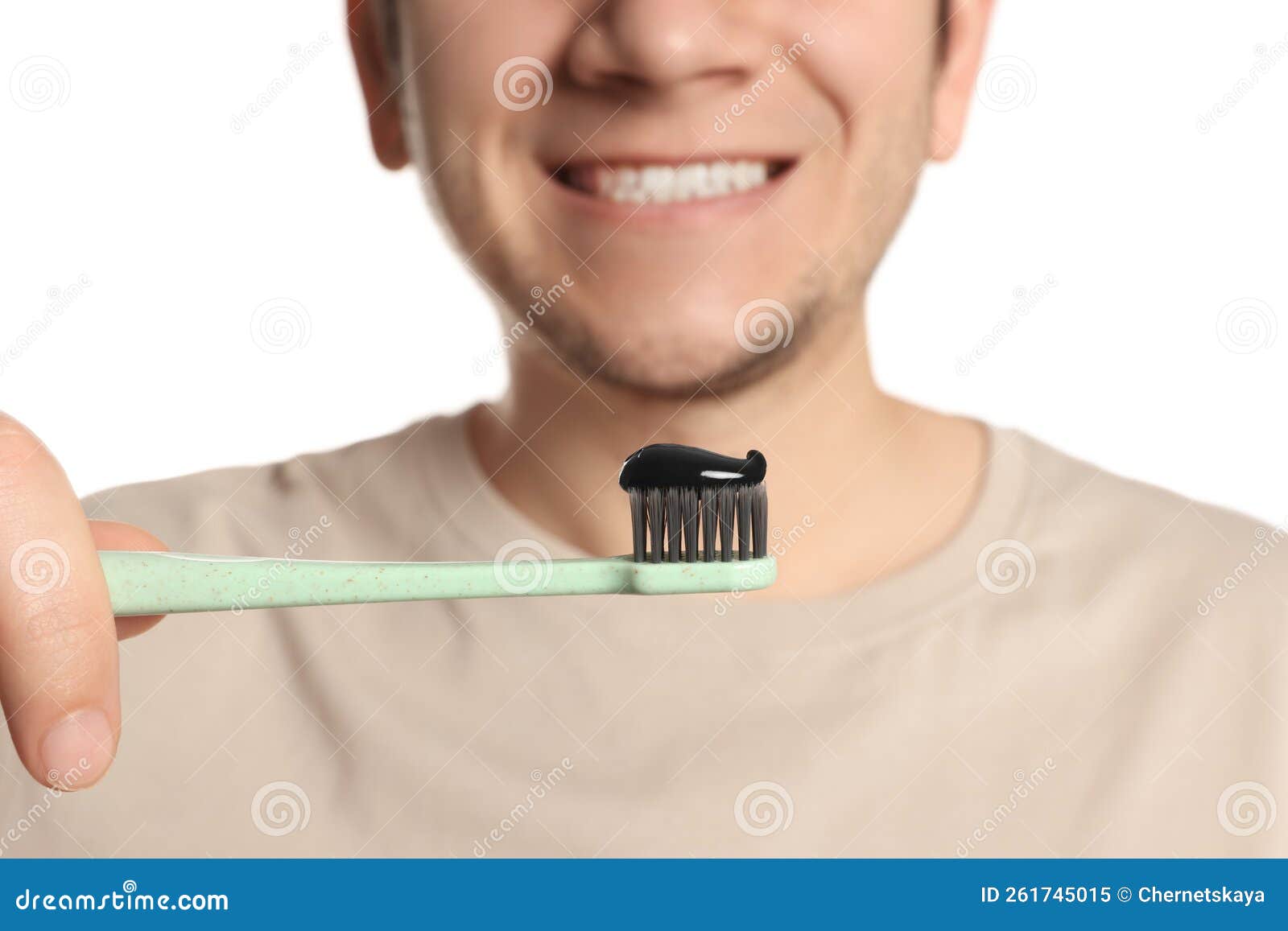 Man Holding Toothbrush with Charcoal Toothpaste on White Background ...