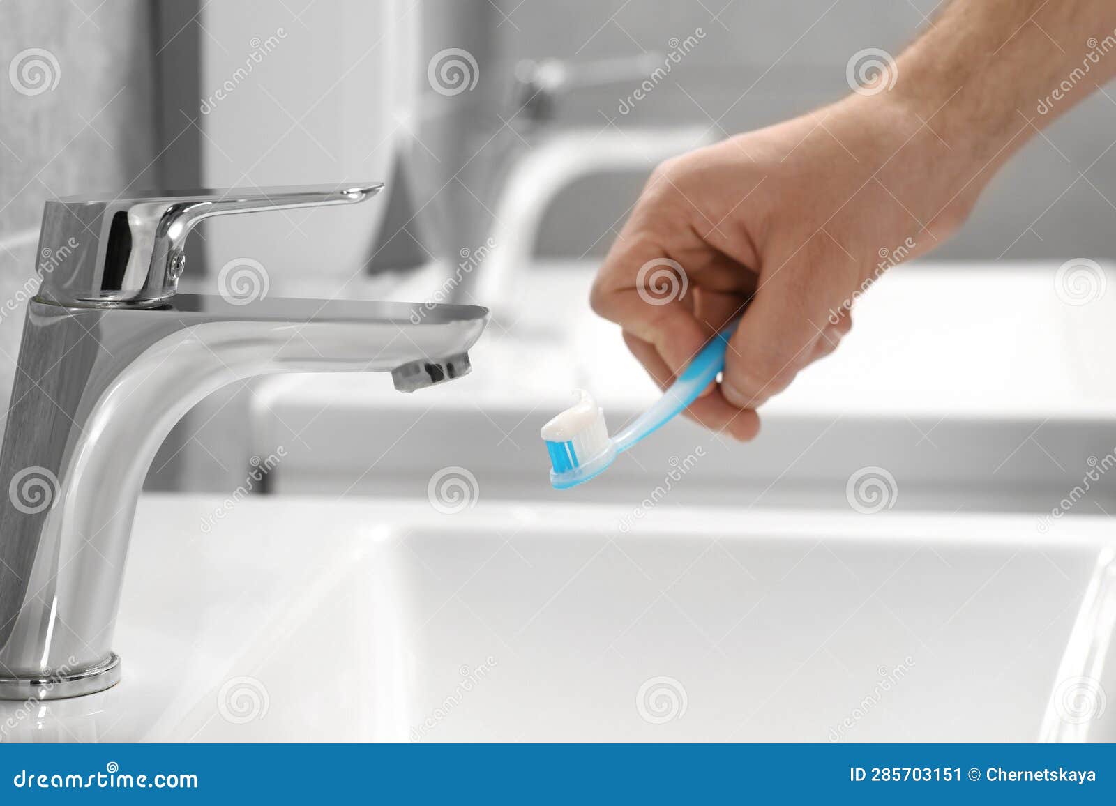Man Holding Toothbrush with Paste Above Sink in Bathroom, Closeup Stock ...