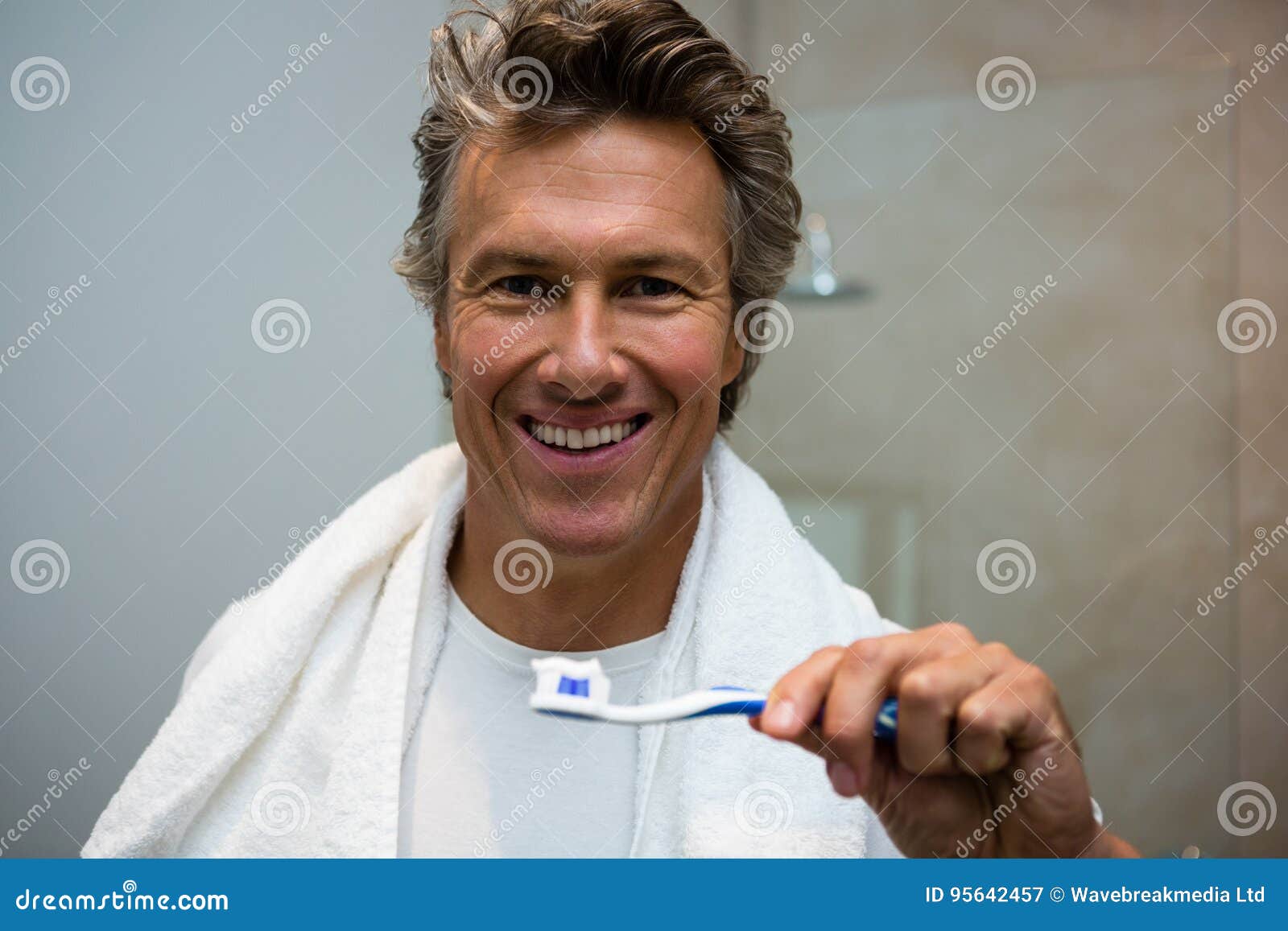 Man Holding Toothbrush with Toothpaste in Bathroom Stock Image - Image ...