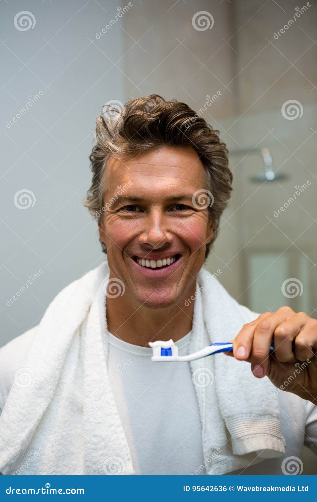 Man Holding Toothbrush with Toothpaste in Bathroom Stock Photo - Image ...