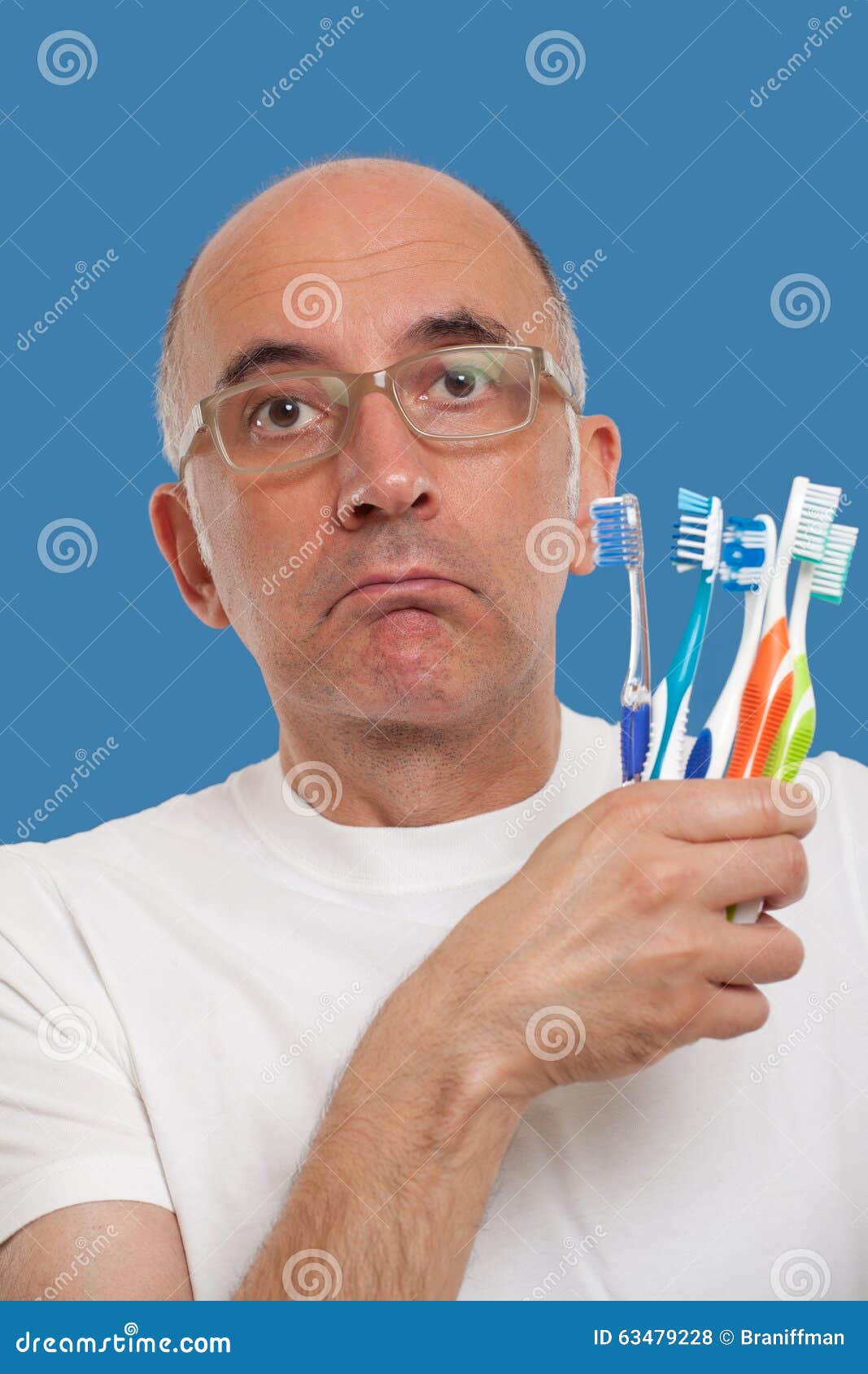 Man holding toothbrushes stock photo. Image of lots, close - 63479228
