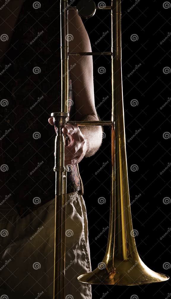 Man holding a trombone stock image. Image of shining - 16482211