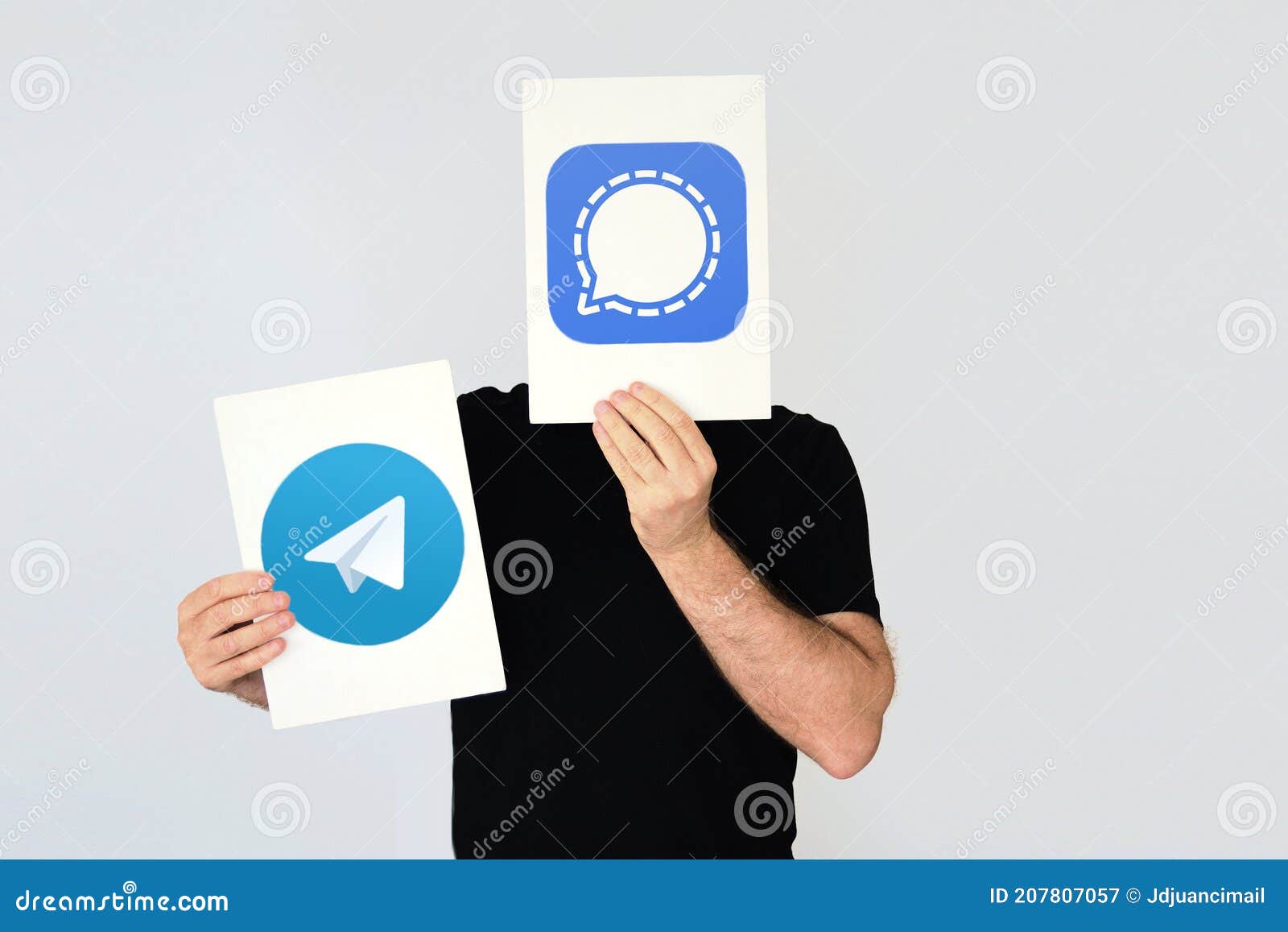 Man Holding Two Cards with the Telegram and Signal Logos on it. Empty ...