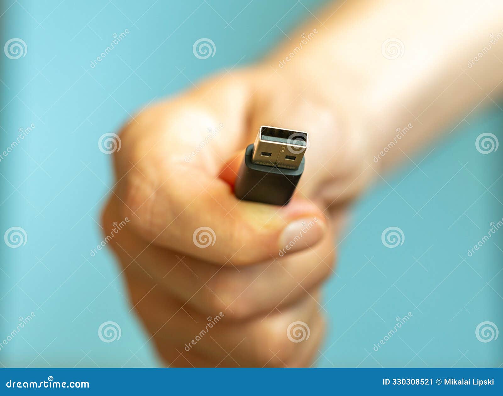 Man Holding USB Cable in Hand on Blue Background, Technology Concept ...
