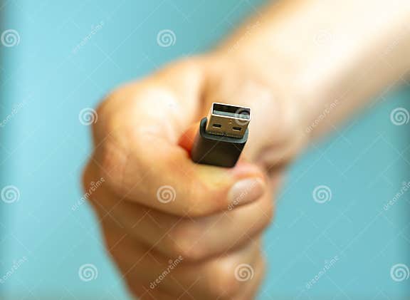 Man Holding USB Cable in Hand on Blue Background, Technology Concept ...