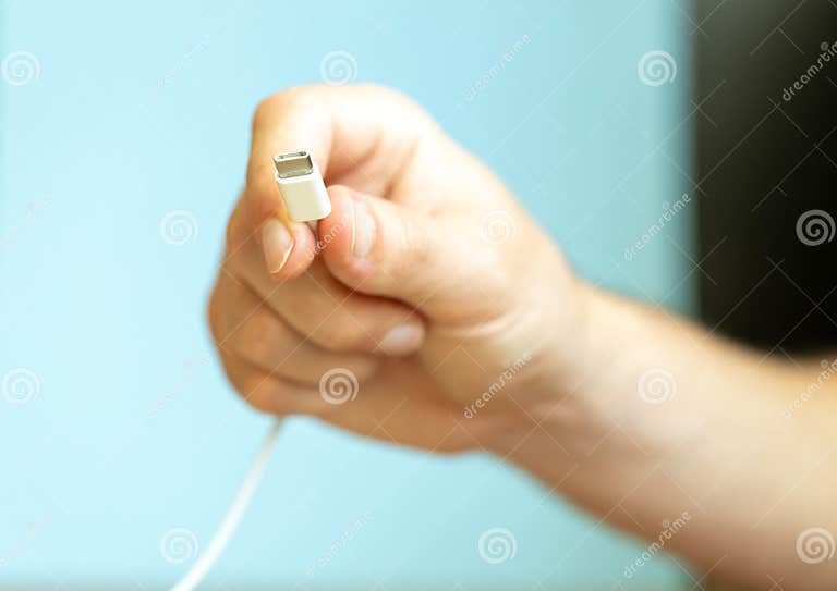 Man Holding USB Cable in Hand on Blue Background, Technology Concept ...