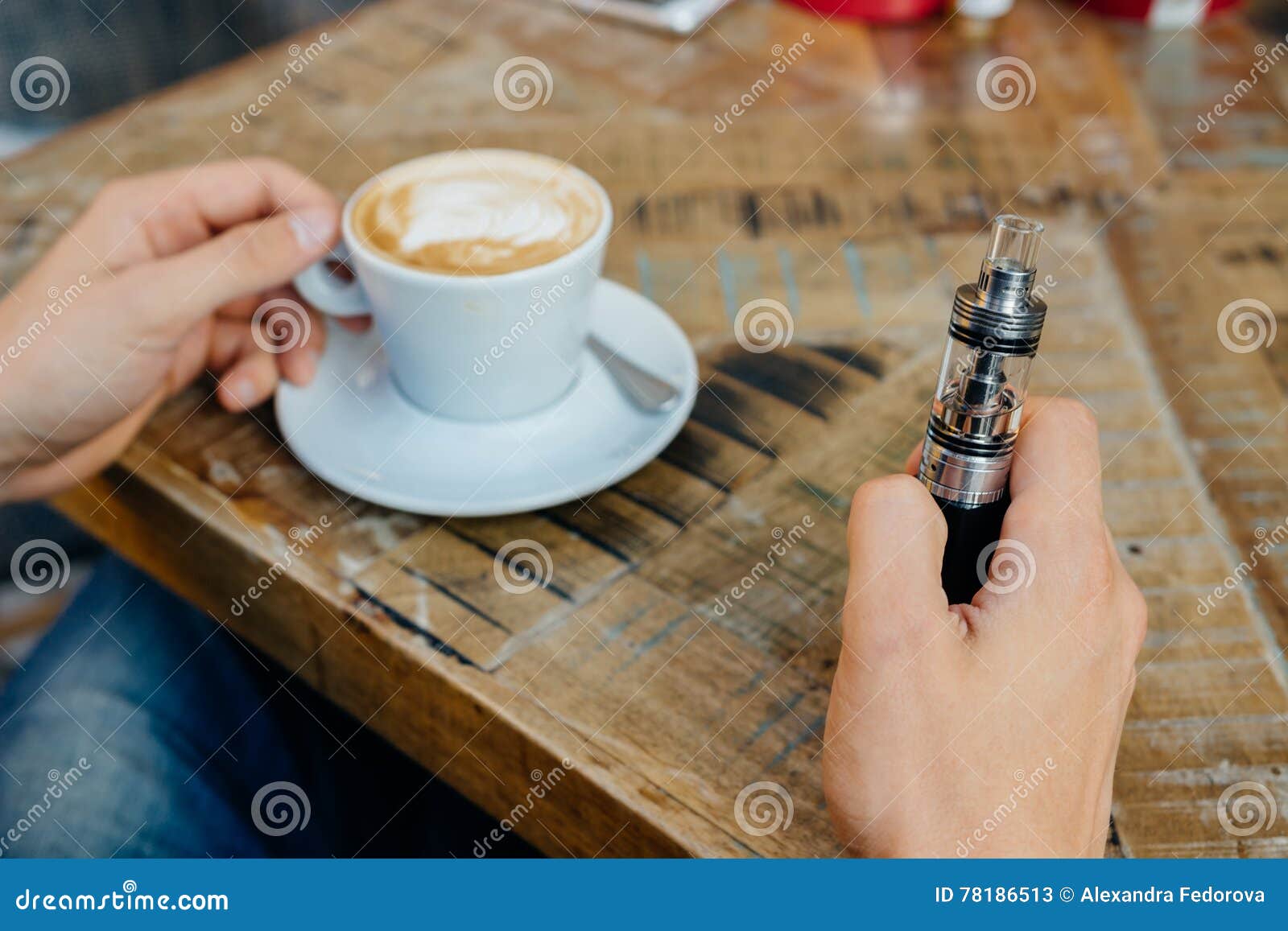 Man Holding Vape or Electronic Cigarette and Drinking Coffee Stock ...