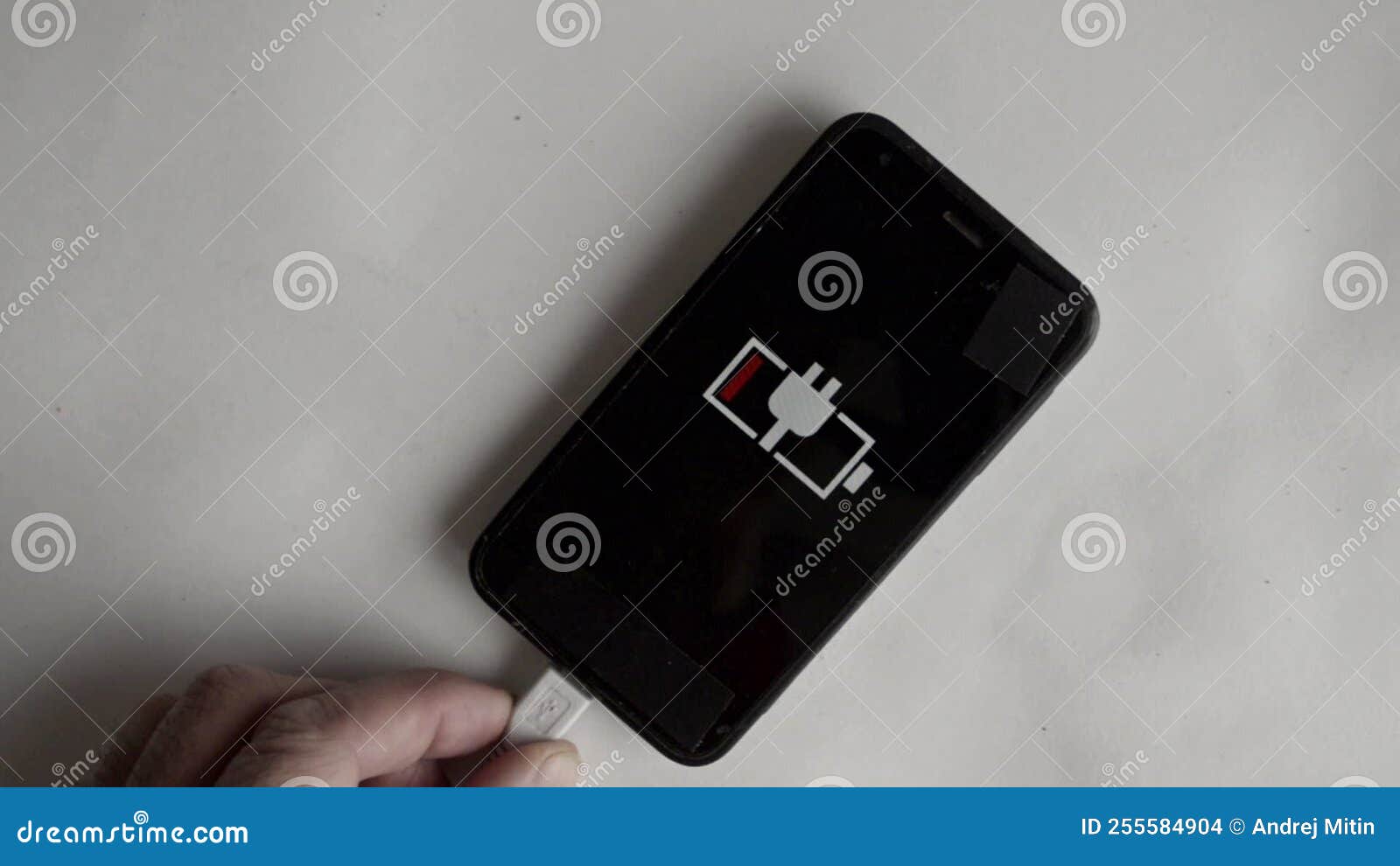 The Man Holds the Charger Cable,the Smartphone Indicator Shows the ...