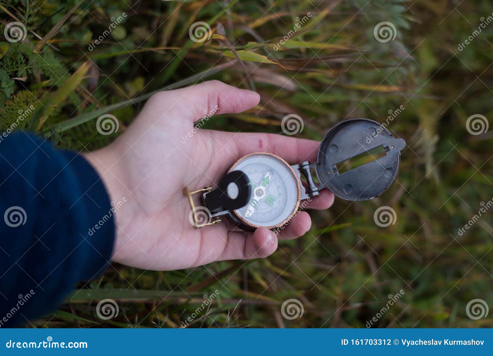 Man Holds a Compass in His Hand. Man Wathing Compass Holding in His ...