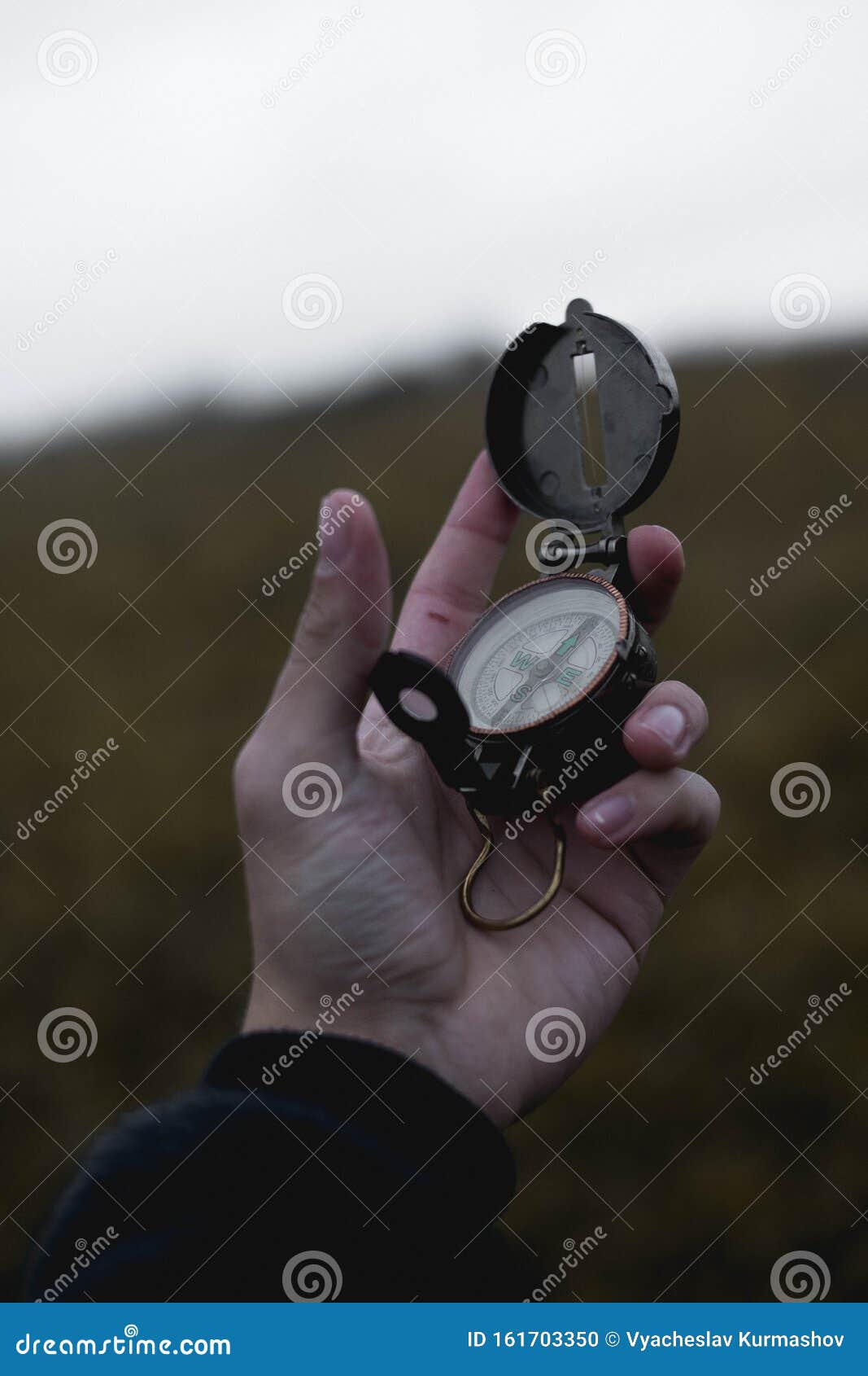 Man Holds a Compass in His Hand. Man Wathing Compass Holding in His ...