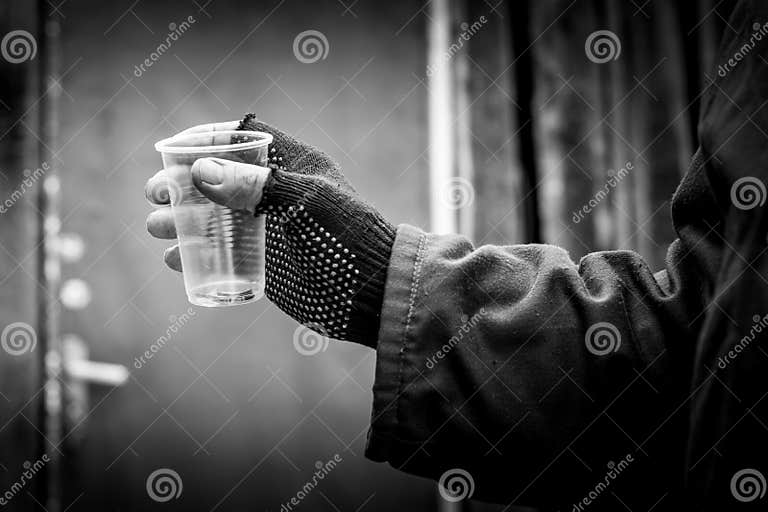 A Man Holds a Cup in an Outstretched Hand. Stock Image - Image of ...