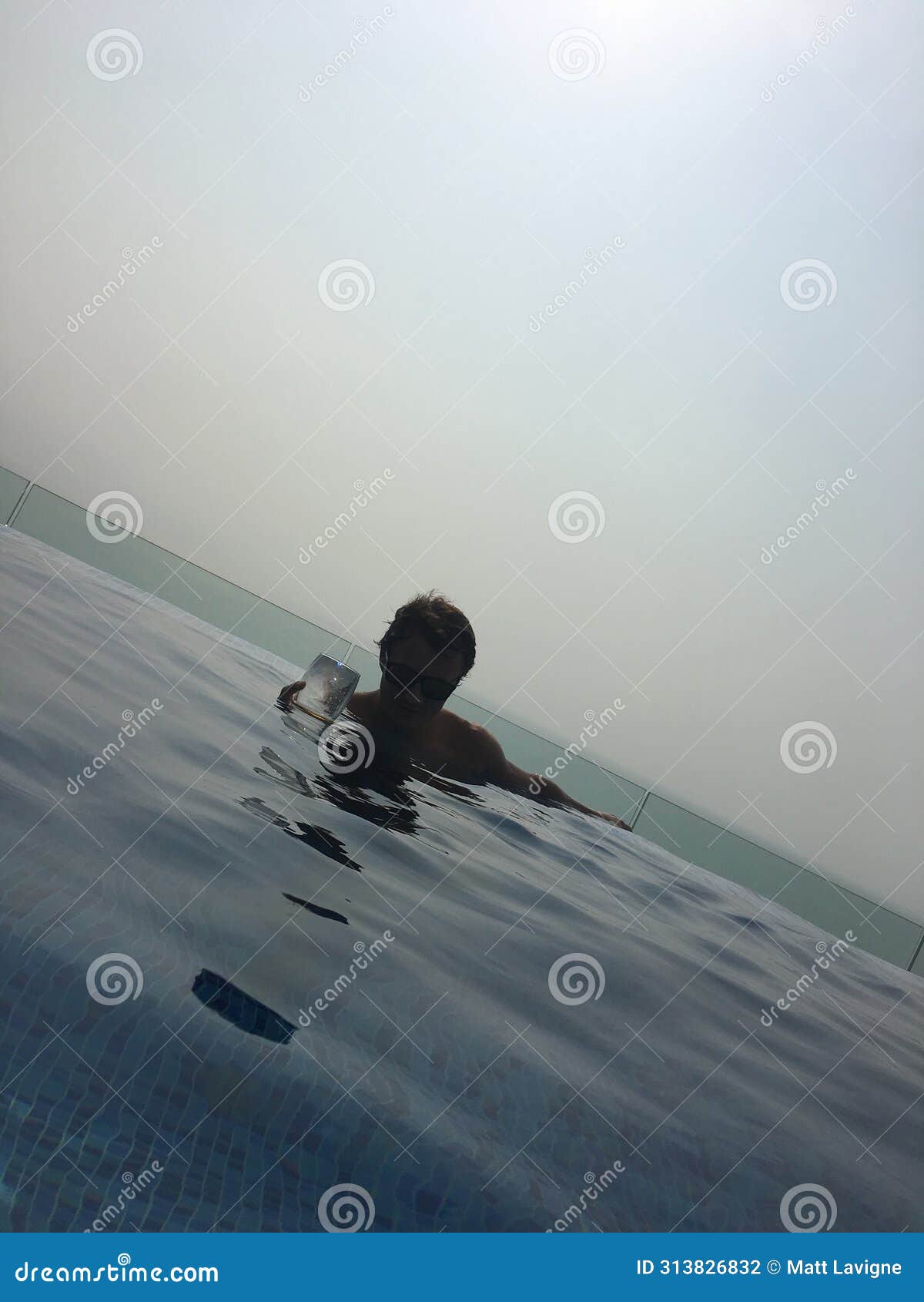 A Man Holds a Glass Up in a Infinity Pool Stock Photo - Image of ...