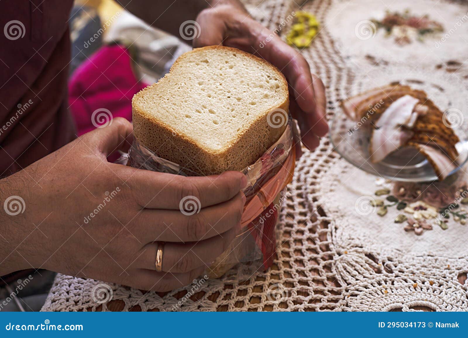 Man Holds Half of Bread in His Hands To Cut it into Pieces Stock Image ...