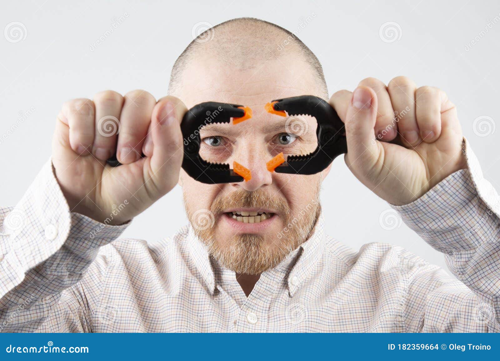 Man Holds in the Hands of Industrial Clamps Stock Photo - Image of ...