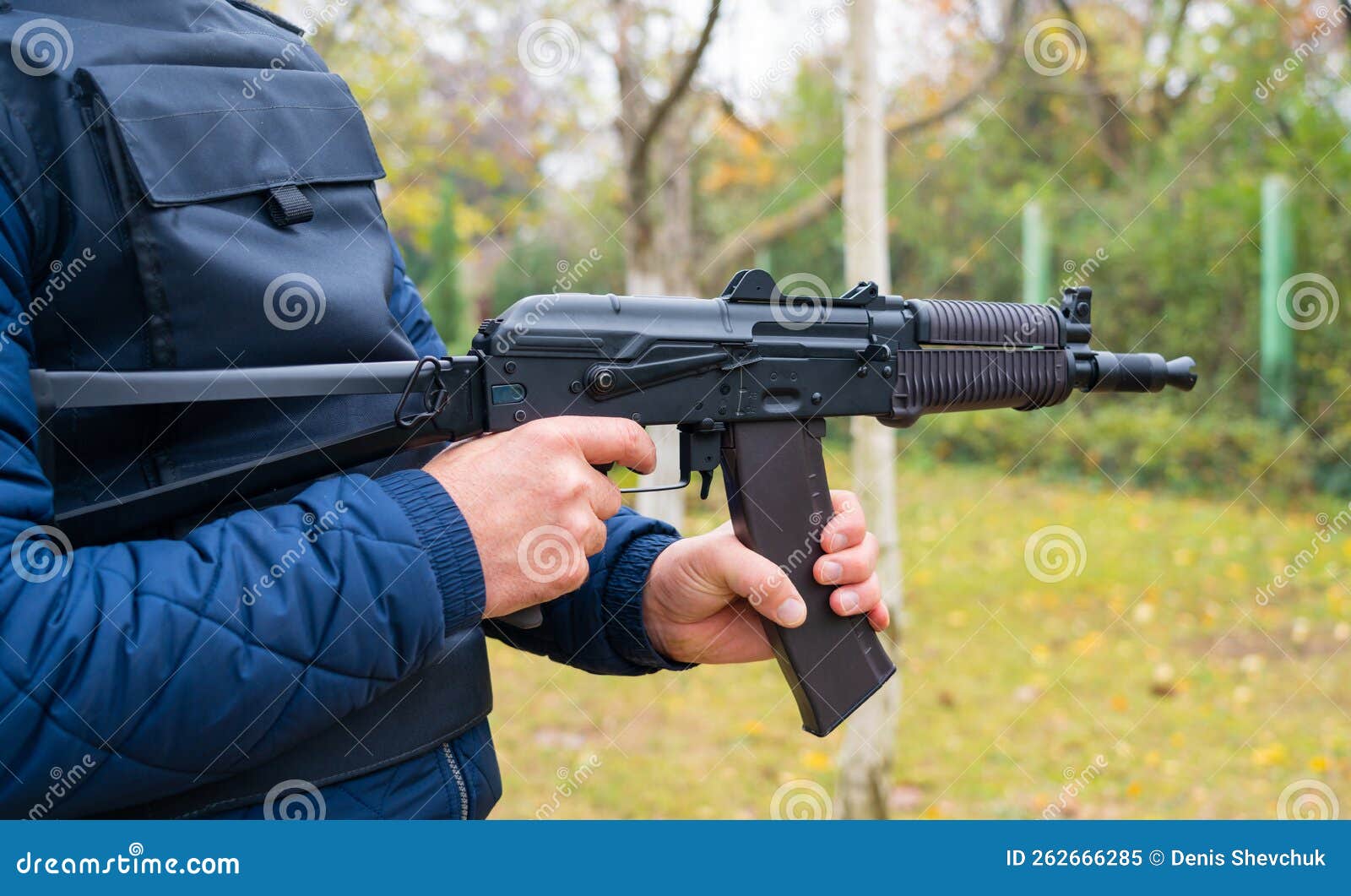 A Man Holds a Kalashnikov Assault Rifle in His Hands Side View Stock ...
