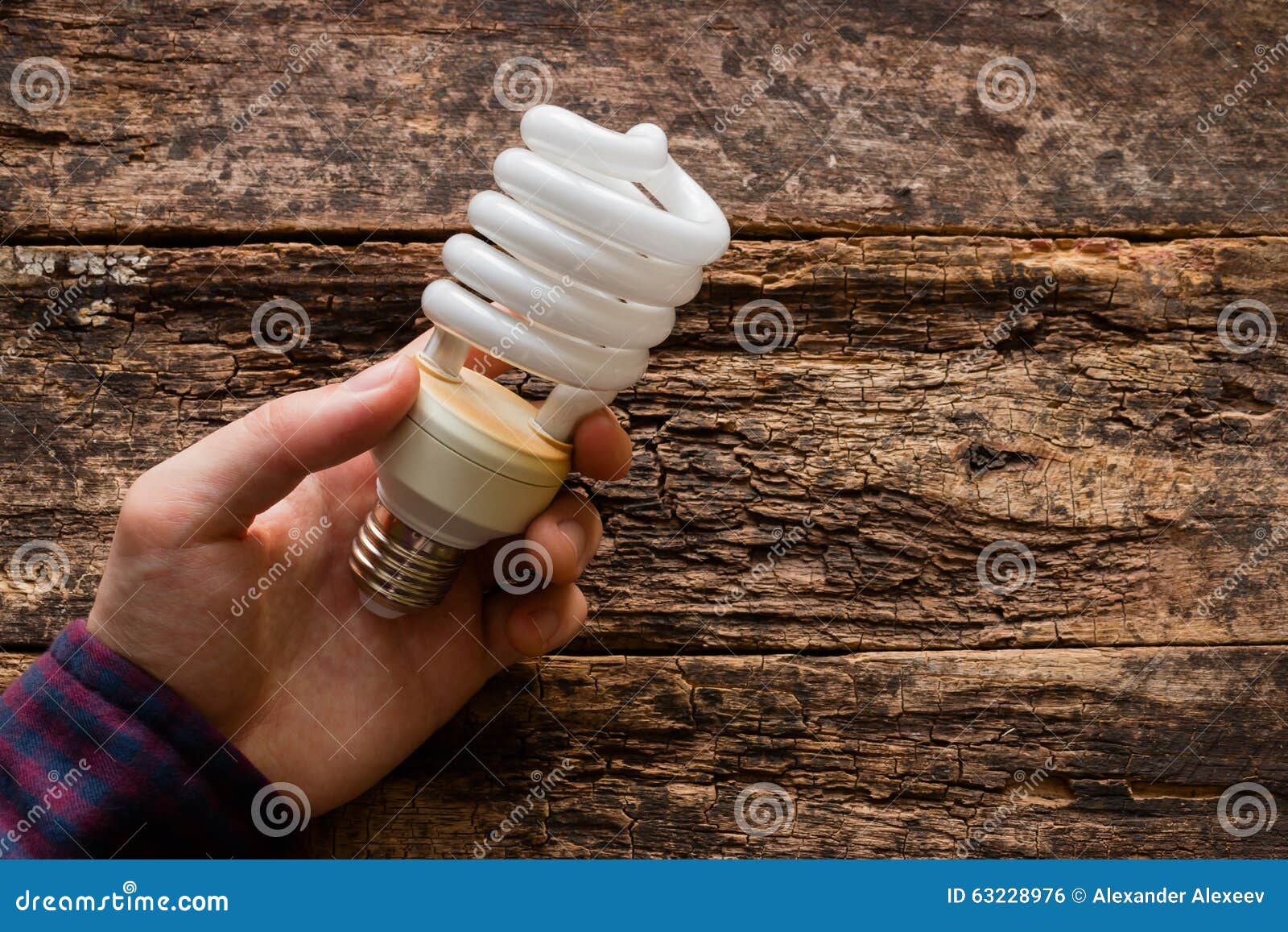 Man Holds a Light Bulb To Save Energy Stock Photo - Image of background ...