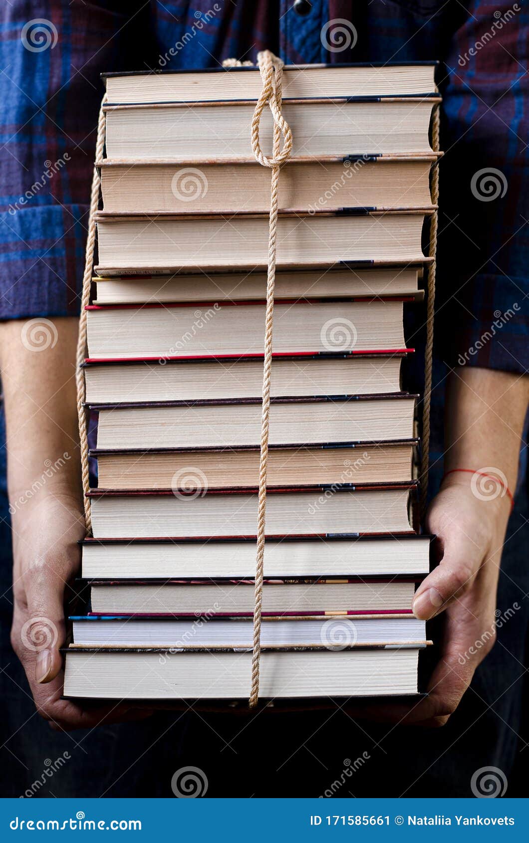 A Man Holds Many Books Tied with a Rope Stock Image - Image of book ...