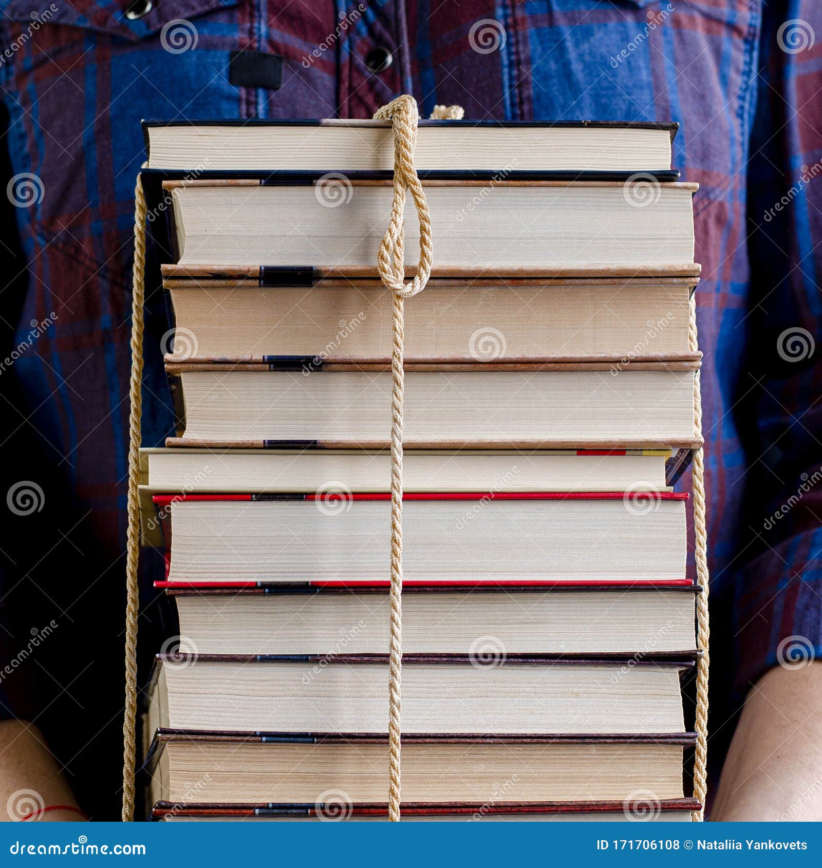 A Man Holds Many Books Tied with a Rope Stock Photo - Image of student ...