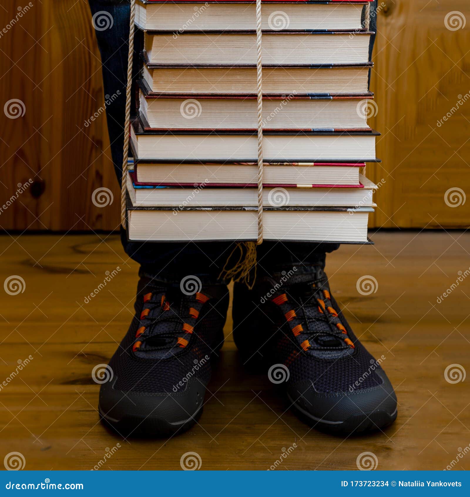 A Man Holds Many Books Tied with a Rope Stock Photo - Image of pile ...
