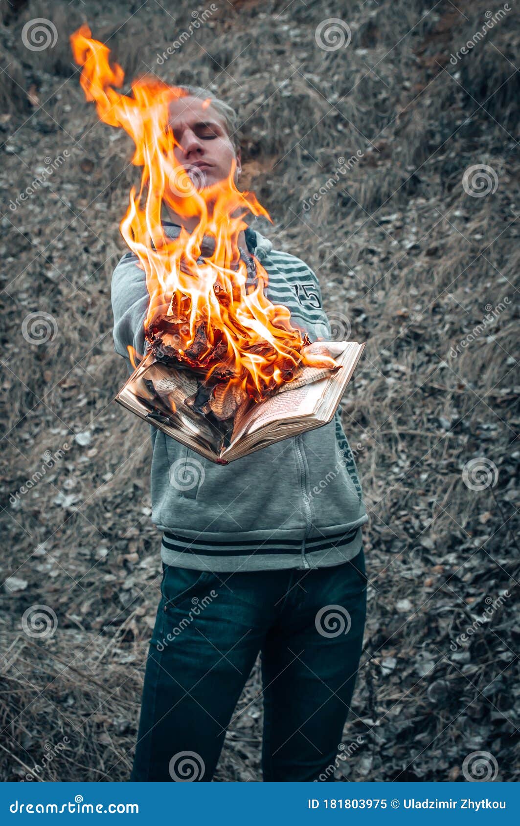 A Man Holds an Open Book in His Hands, the Pages of Which Burn with a ...