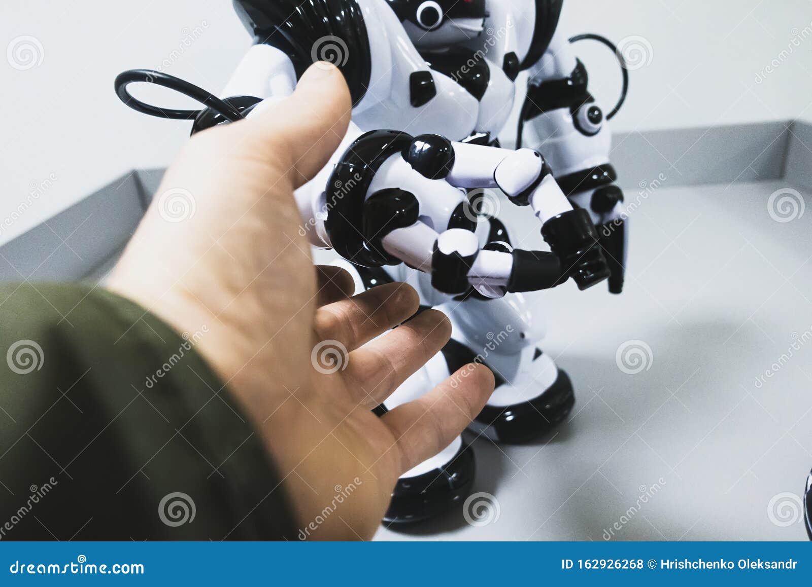 The Man Holds Out His Hand To the Robot Stock Photo - Image of ...