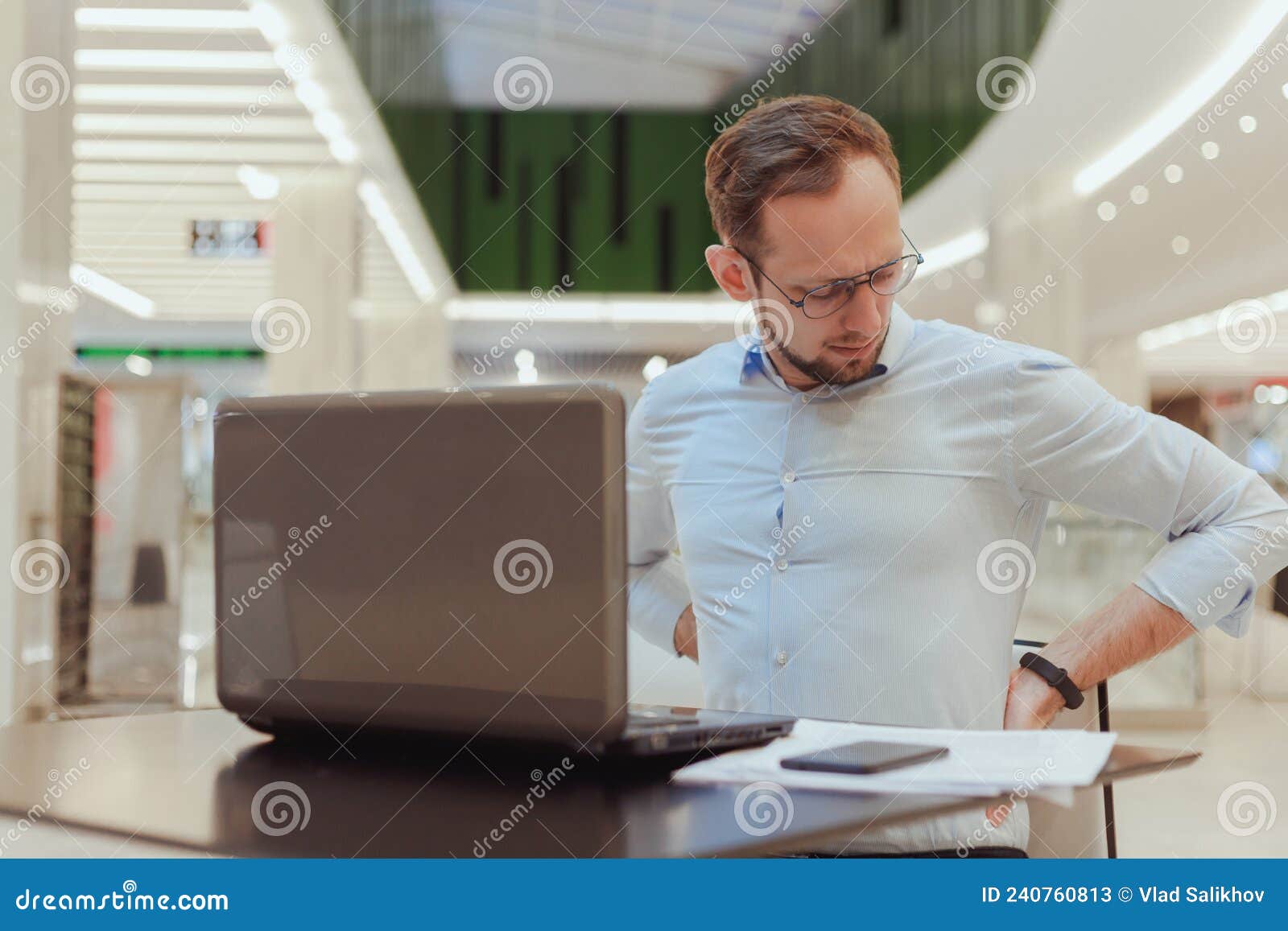 Man Holds on To His Back, Suffers from Lower Back Pain, Working on ...