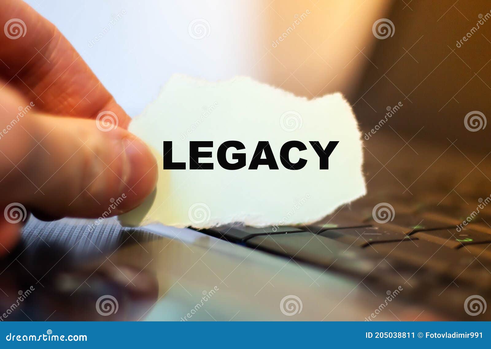 A Man Holds a Torn Piece of Paper with the Word Legacy Stock Image ...
