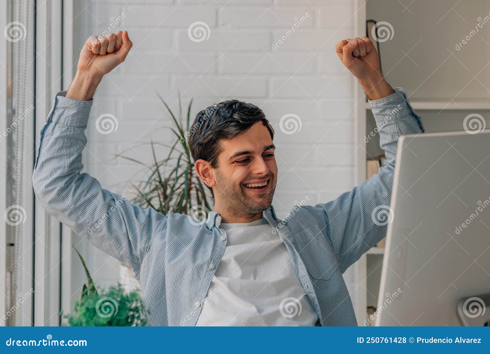 Man at Home Celebrating Success Looking at Computer Stock Photo - Image ...