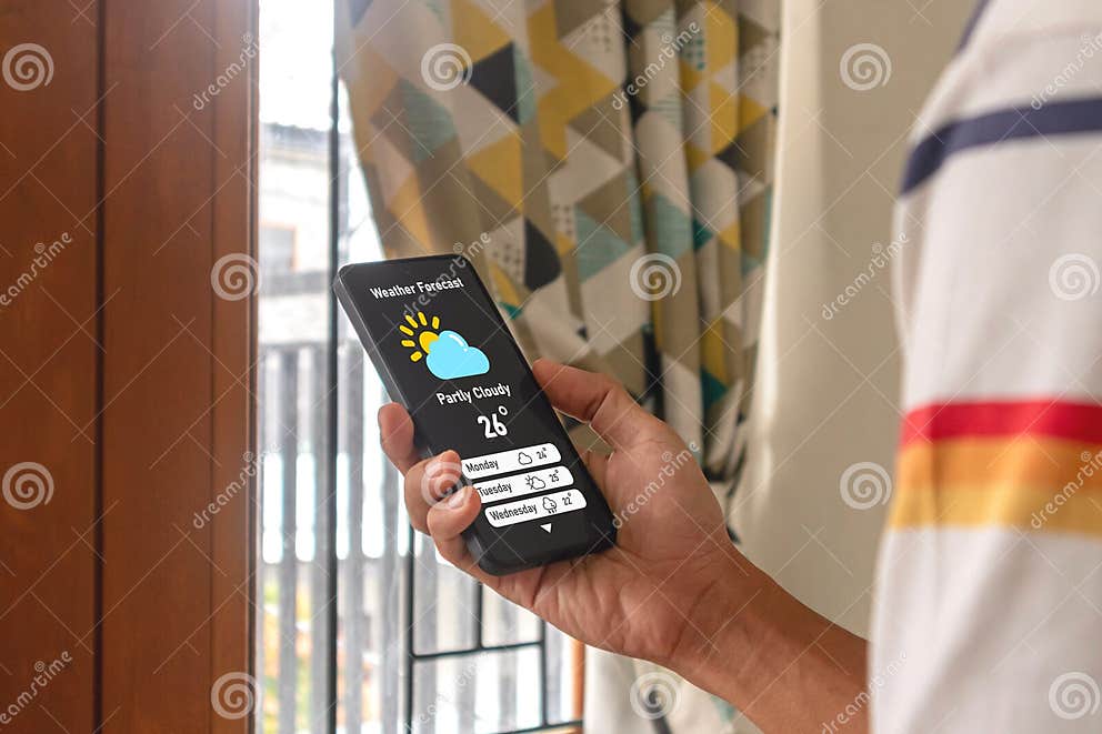 A Man at Home Checking the Weather Forecast Using an App on His ...