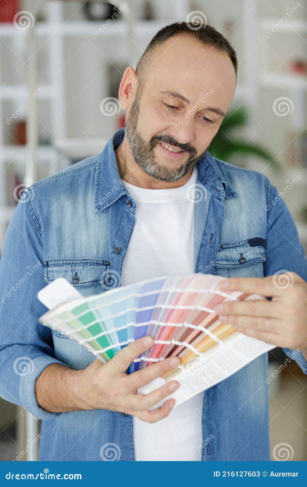 Man at Home Looking through Paint Colour Charts Stock Image - Image of ...