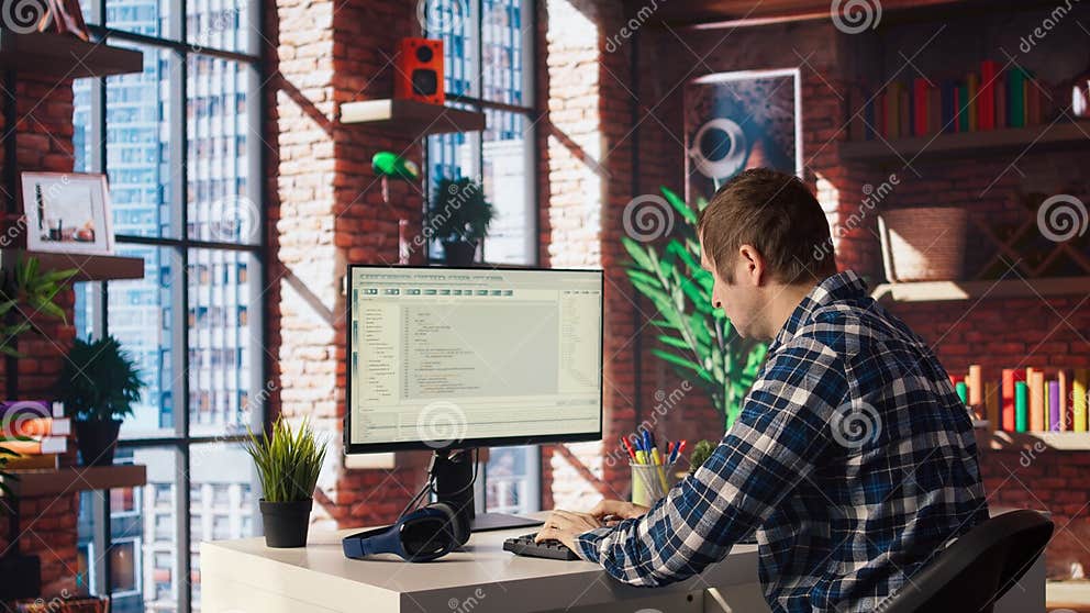 Man at Home Looking at UI on PC Screen, Typing and Executing Programming Code Stock Photo ...