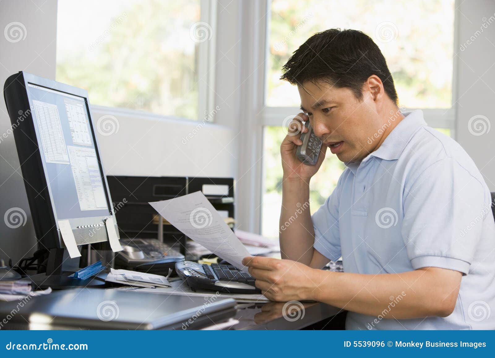 Man in Home Office with Computer and Paperwork Stock Photo - Image of ...