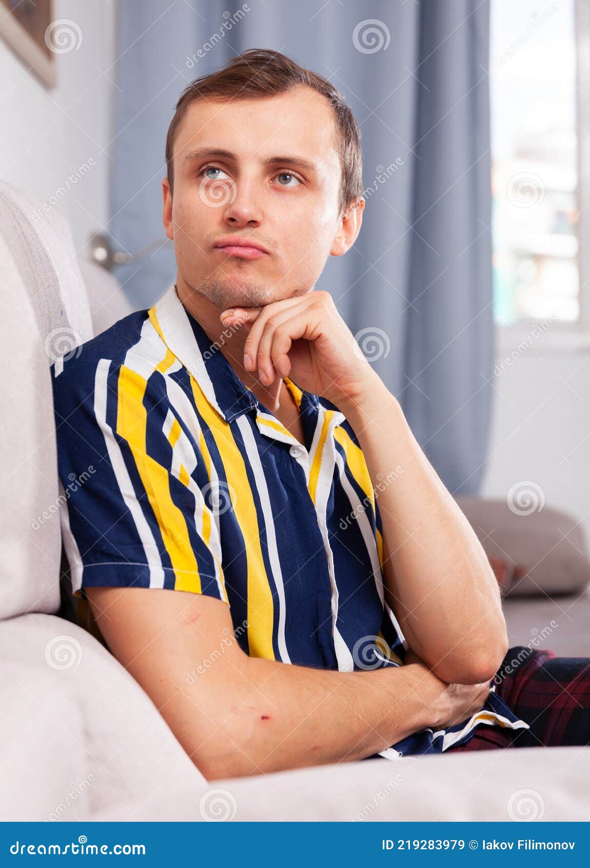 Man in home stock image. Image of smiling, sofa, young - 219283979