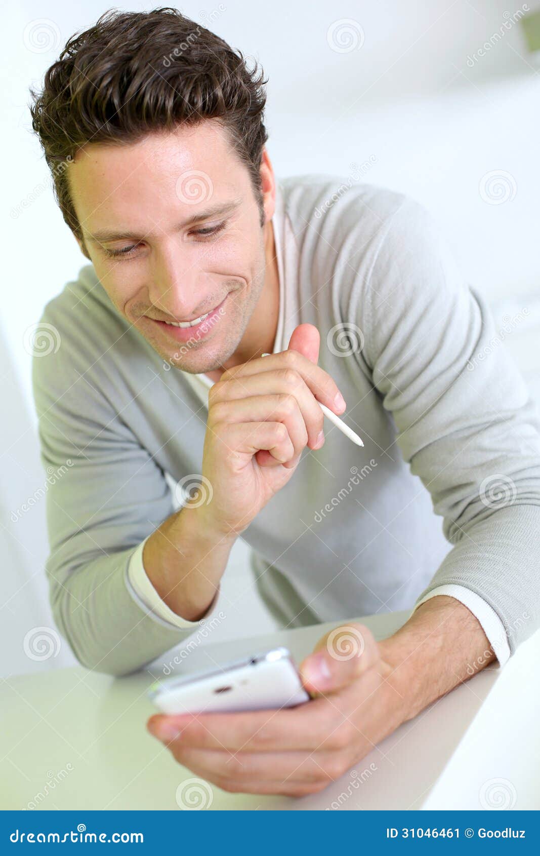 Man at Home Using Smartphone Stock Image - Image of blue, smiling: 31046461