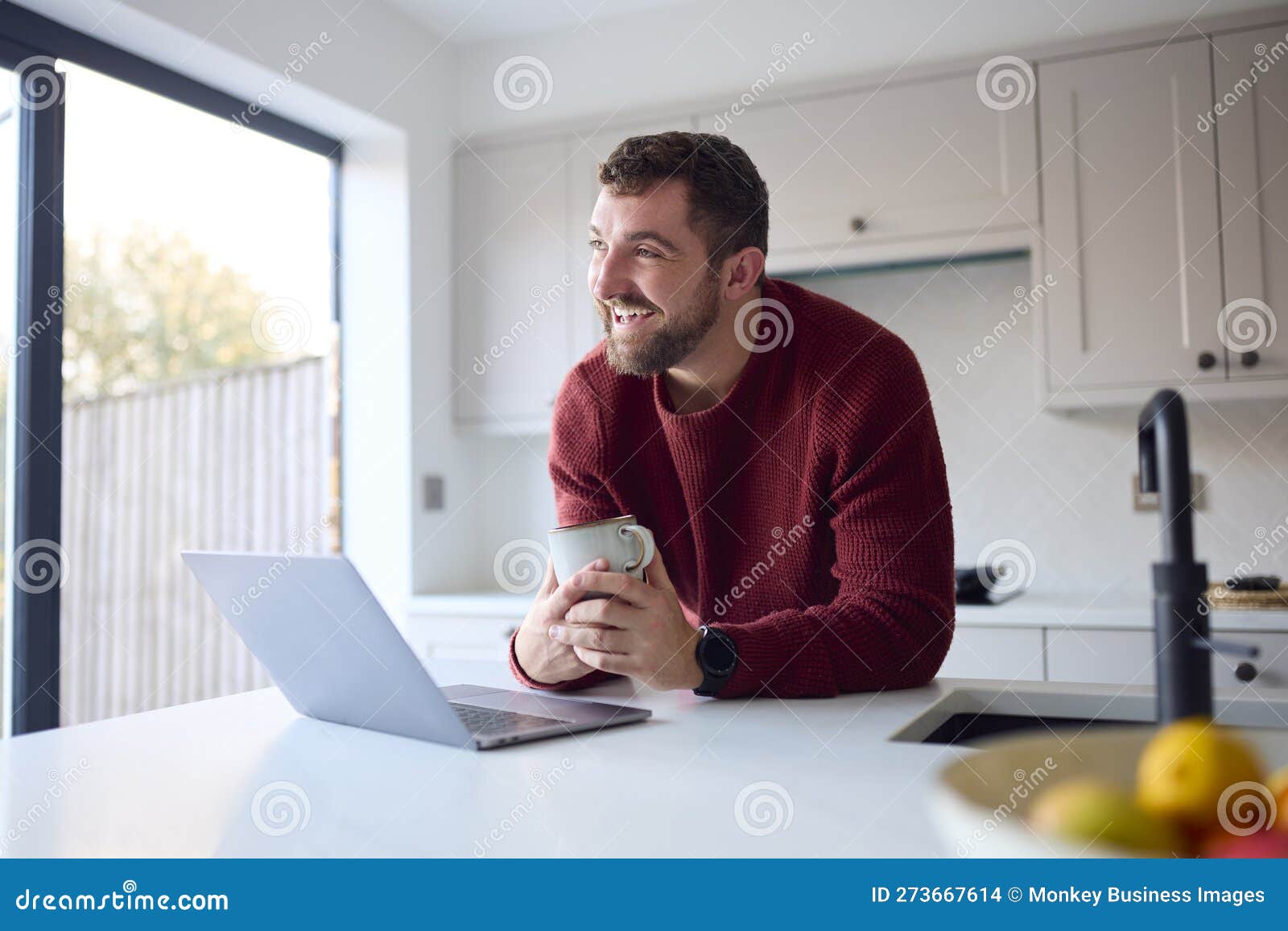 Man at Home Working on Laptop on Counter in Kitchen Stock Photo - Image ...