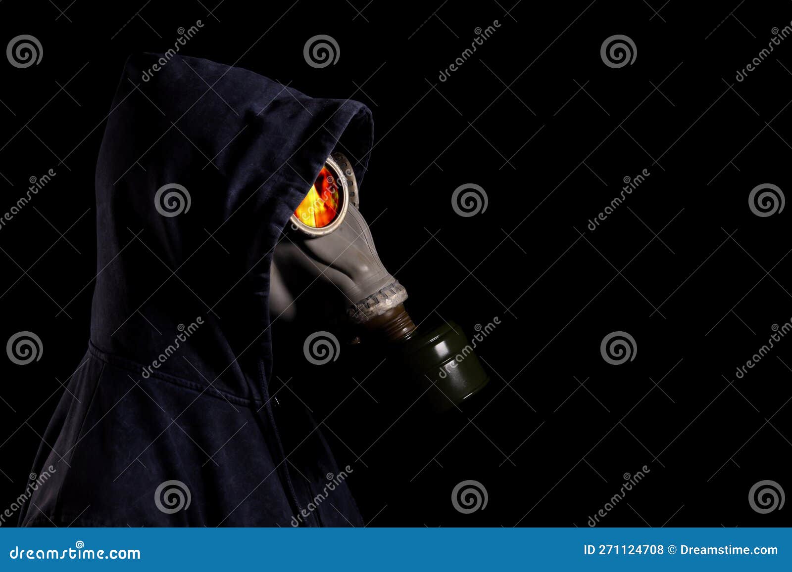 A Man in a Hood in a Gas Mask with a Reflection of Fire in the Glasses ...