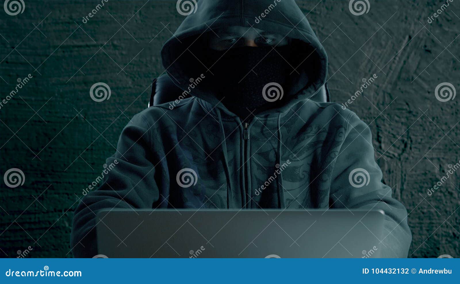 A Man in Hood Sitting at Table and Coding on Laptop. Dark Night. Front ...