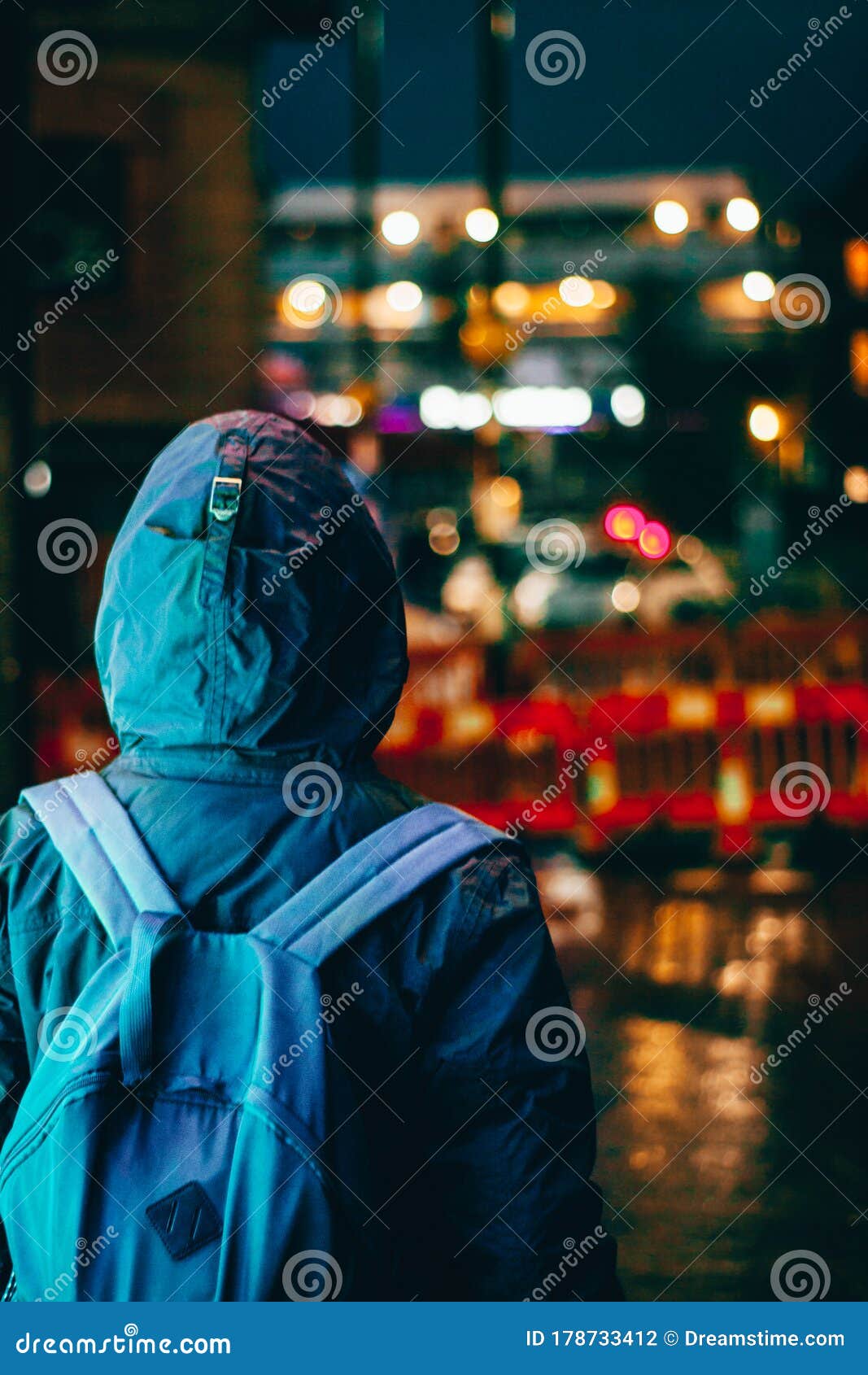 Man with Hood Up Looking at Town Lighting Stock Photo - Image of town ...