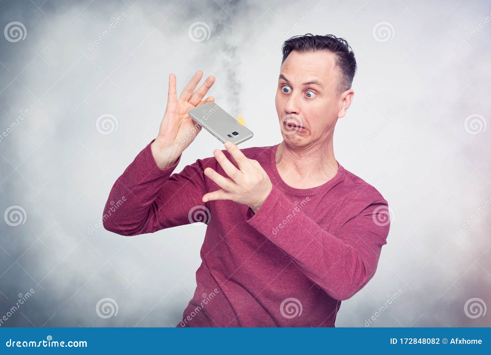 Man in Horror Looks at a Smartphone Burning in His Hands. Mobile Device ...