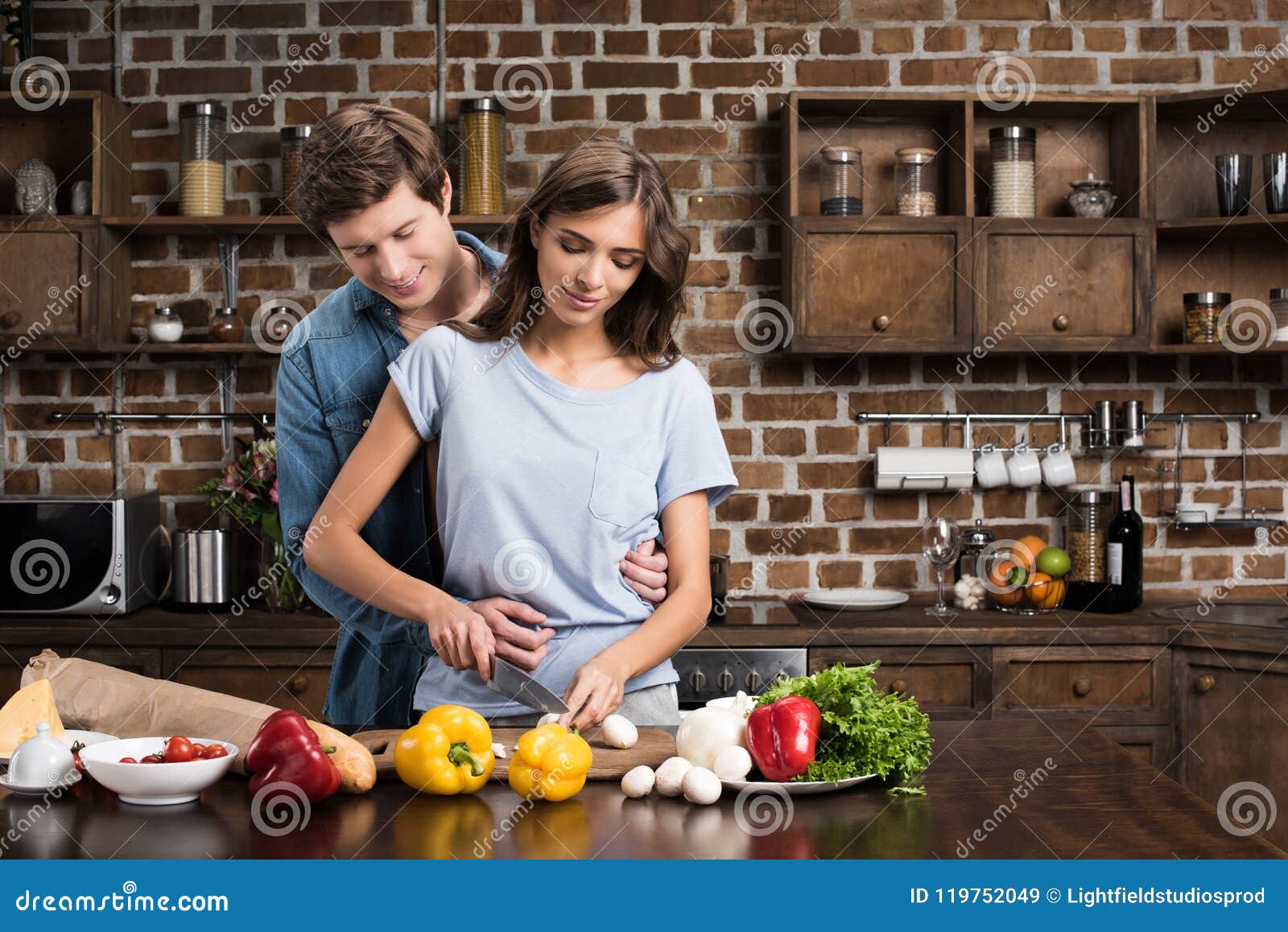 Man Hugging Girlfriend while she Cooking Dinner in Kitchen Stock Image ...