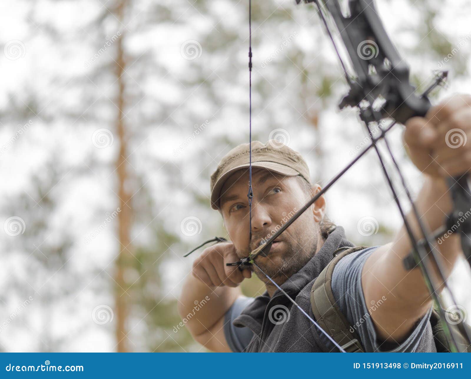 Man Hunts in the Forest with a Bow. the Hunter Aims. Stock Photo ...