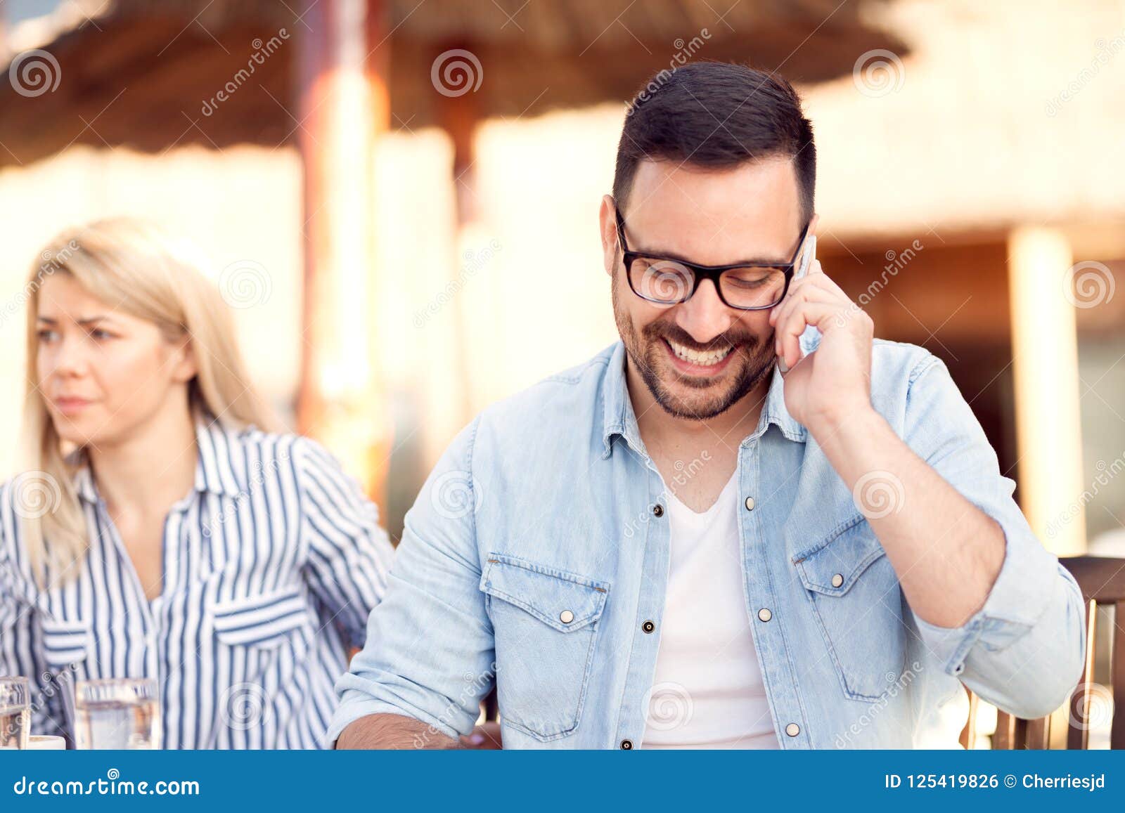Man Ignoring His Girlfriend while Talking on the Phone Stock Photo ... Man Ignoring His Girlfriend while Talking on the Phone Stock Photo ...