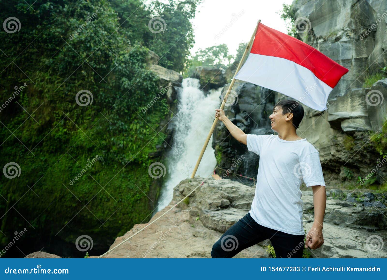 Man with Indonesian Flag of Indonesia in Waterfall with Beautiful View ...