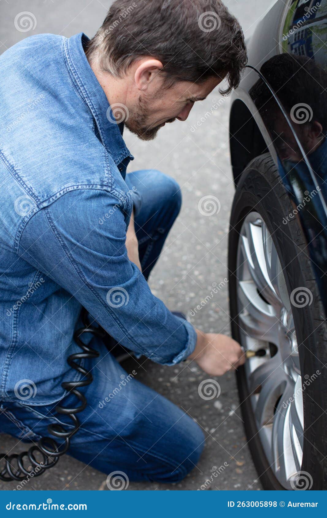 Man inflate car tire stock photo. Image of tshirt, working - 263005898